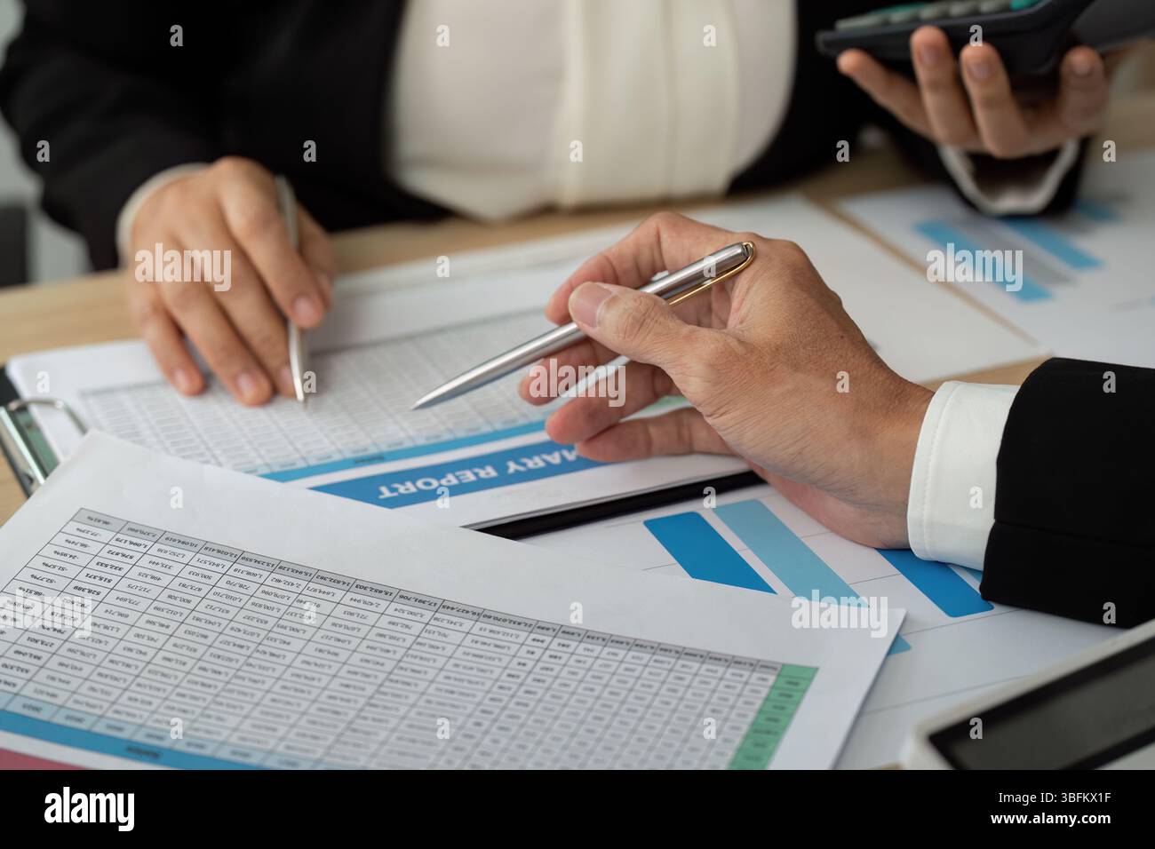 Detailed Financial Analysis. Accountant reviewing data with a pen Stock ...