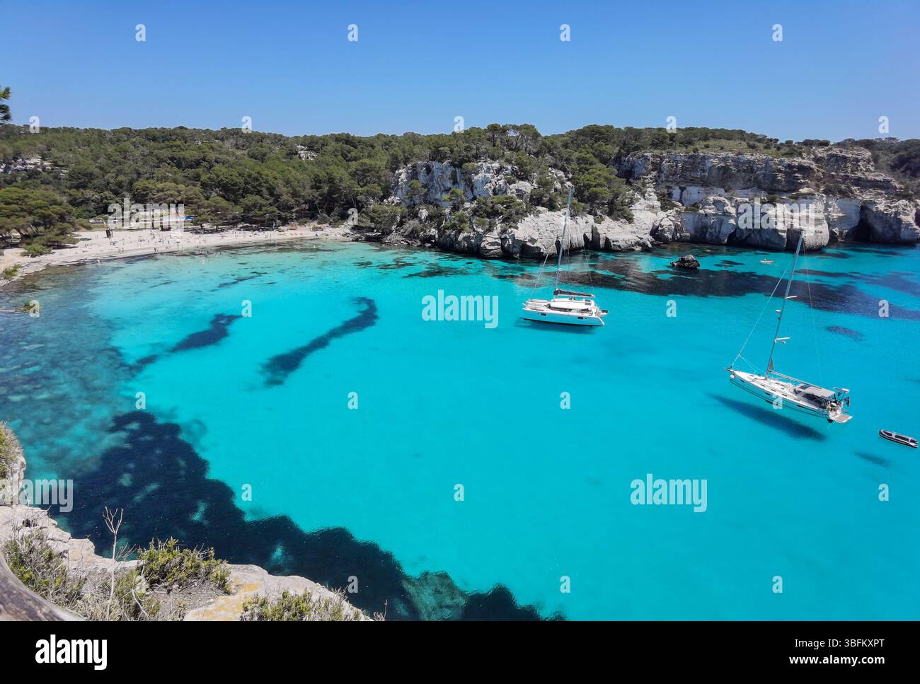 Impressively turquoise waters with boats seemingly floating over translucent shadows, surrounded ...