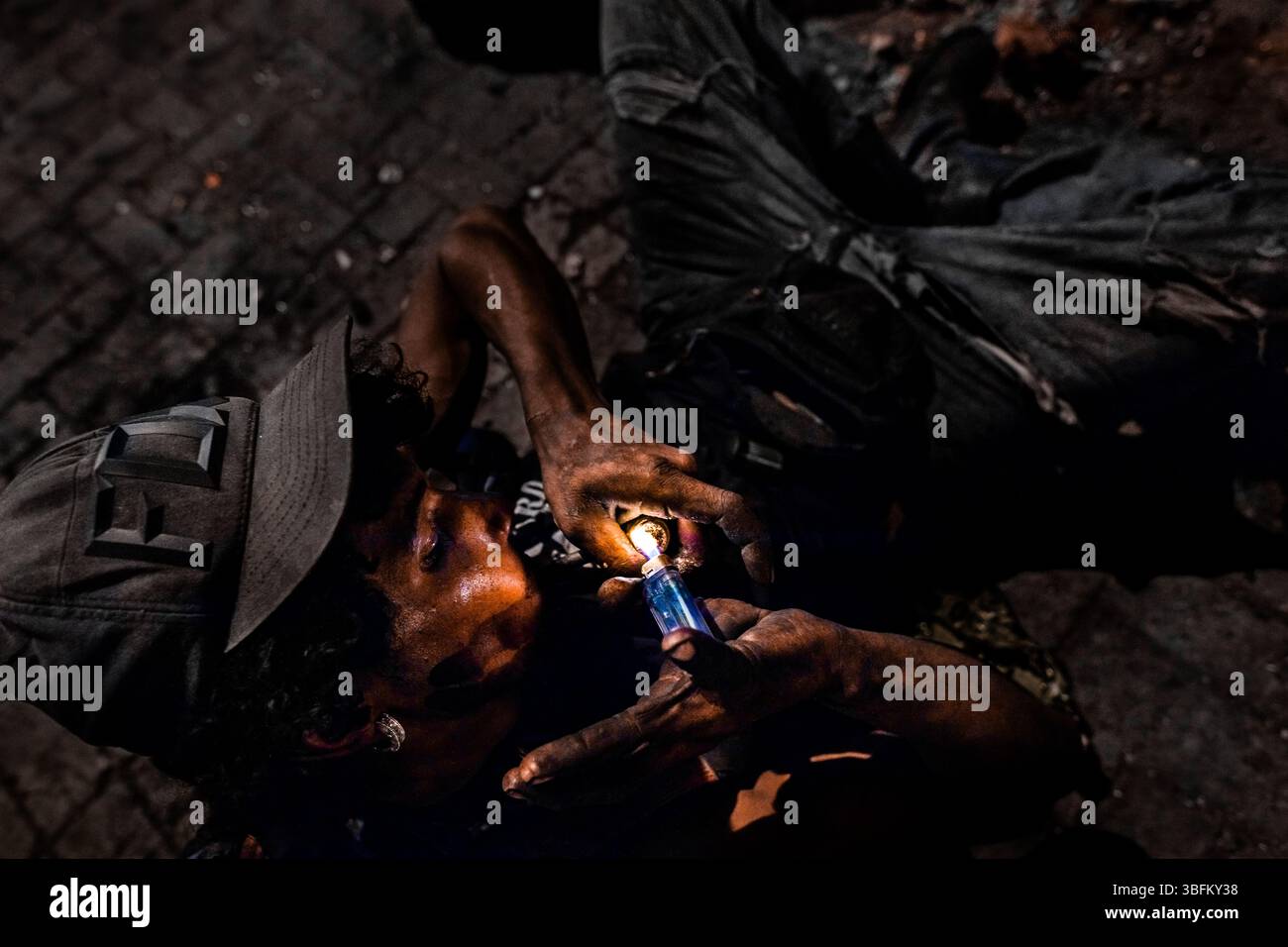 A Colombian drug user smokes basuco – an unrefined, dirty cocaine paste ...