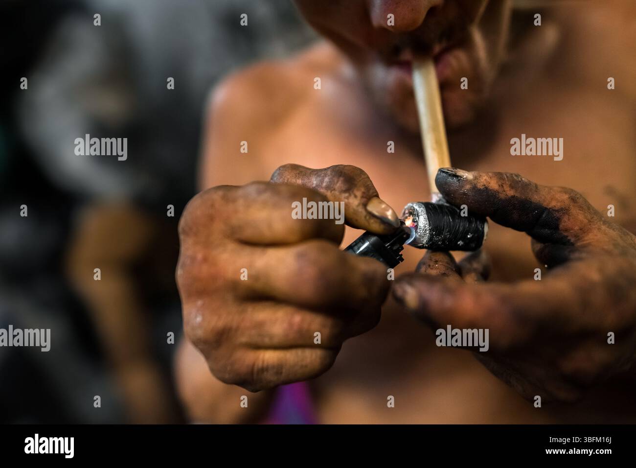 A Colombian drug user smokes basuco – an unrefined, dirty cocaine paste ...
