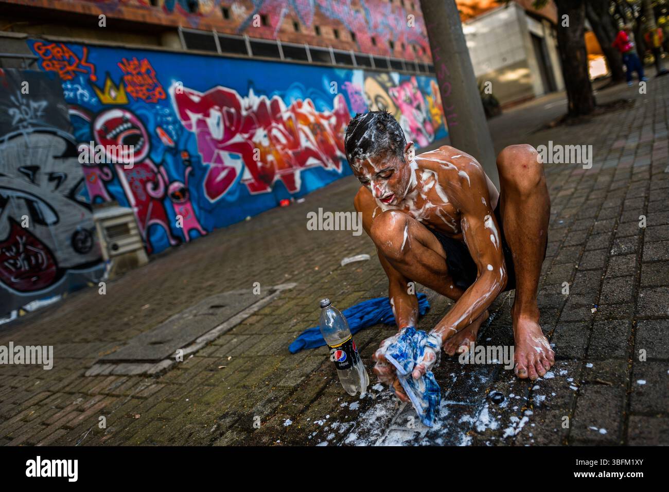 A Colombian drug user carries out personal hygiene and washes his ...