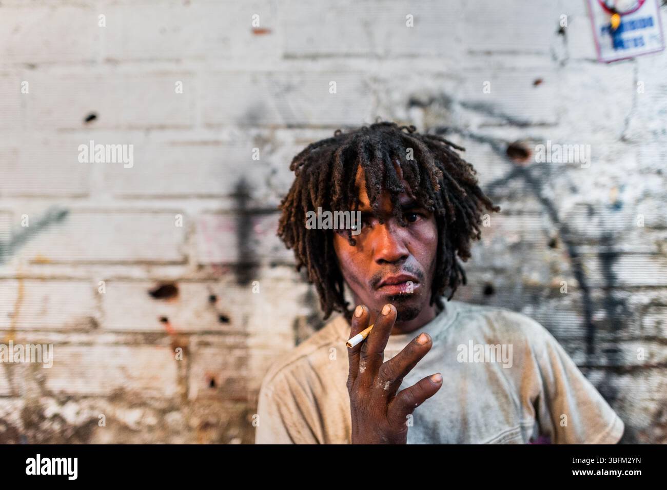 A Colombian drug user poses for a picture while unloading street ...