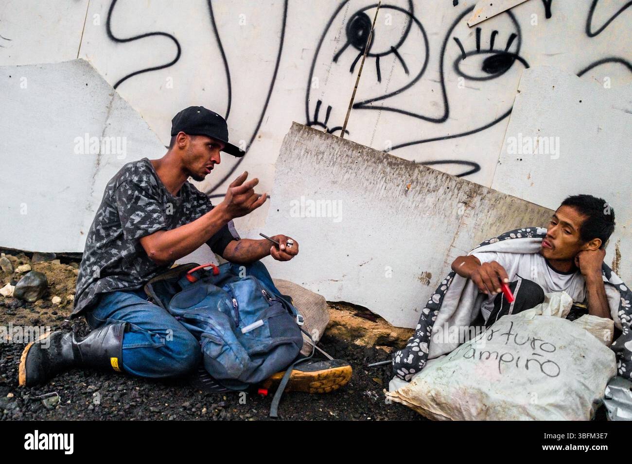 A Colombian drug user smokes a pipe of basuco – an unrefined, dirty ...