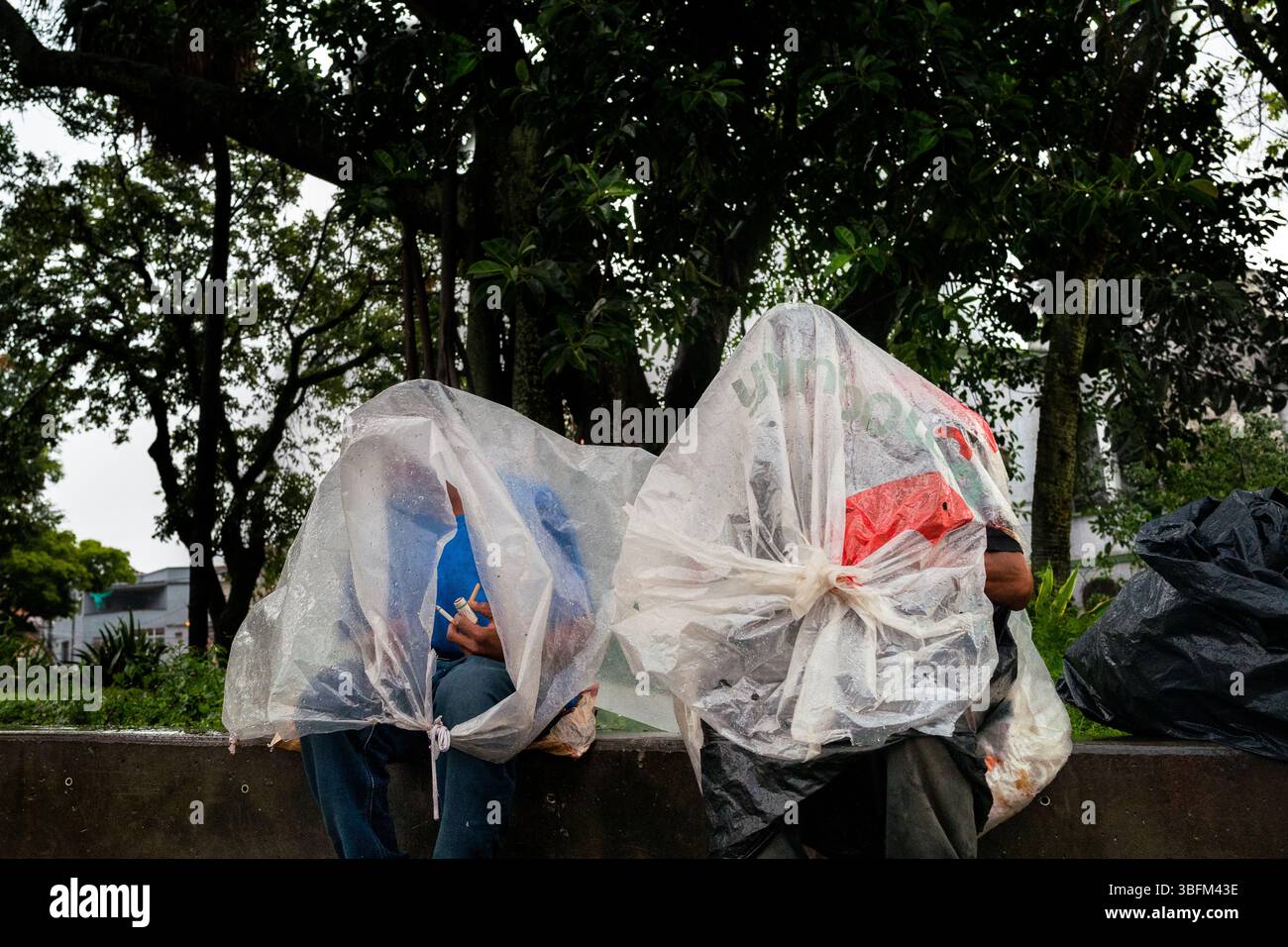 Colombian drug users, hiding from the rain, smoke basuco – an unrefined ...