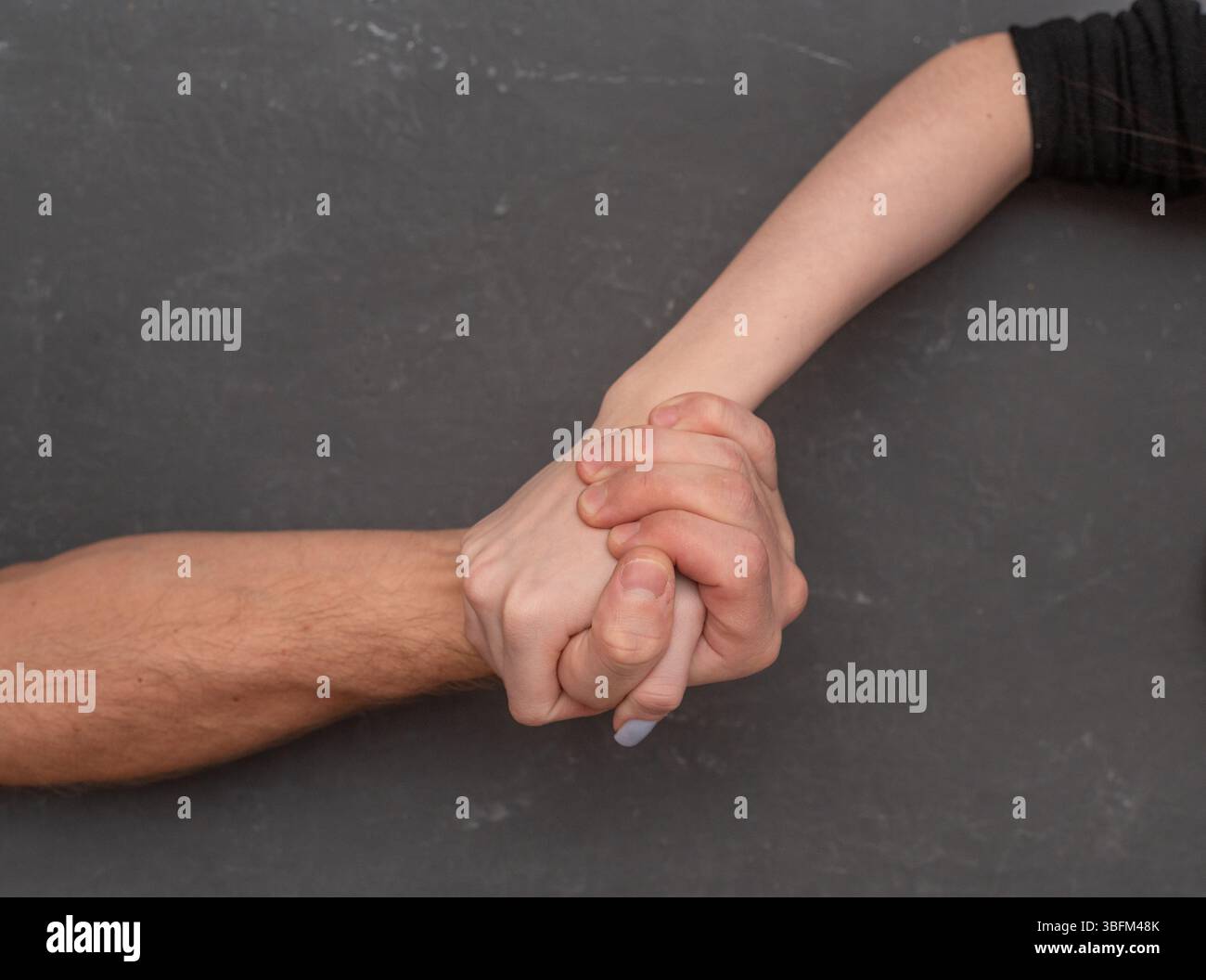 An arm wrestling challenge between a man and a woman. Female power ...