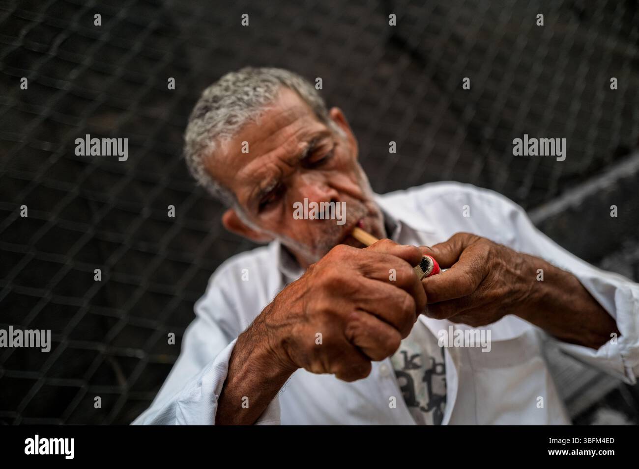A Colombian drug user smokes basuco – an unrefined, dirty cocaine paste ...