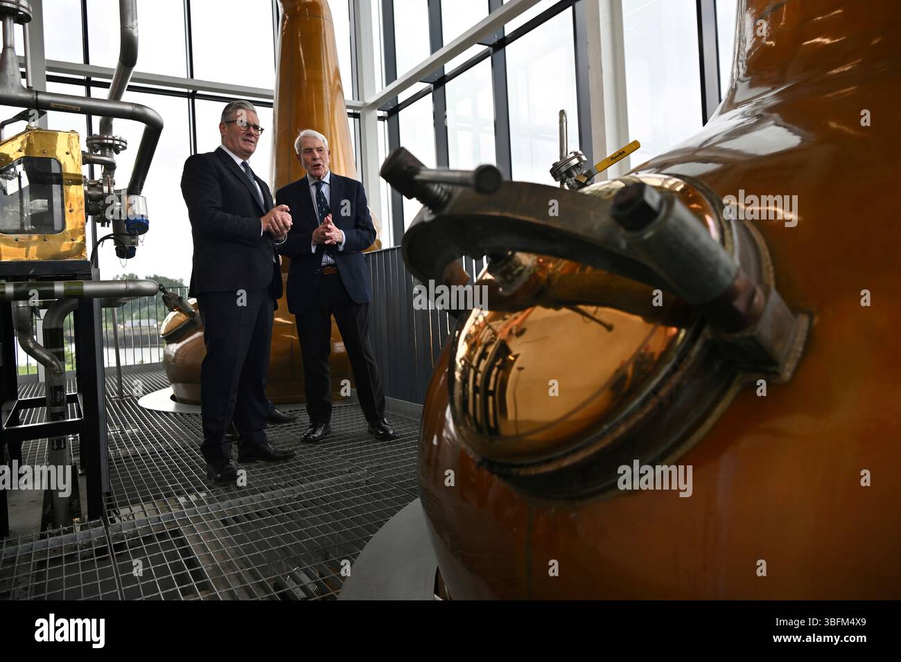 Britain's Prime Minister Keir Starmer, left, listens to Clydeside ...