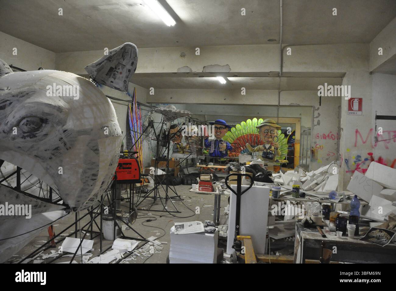 Messy art studio filled with colorful, cartoonish sculptures and ...