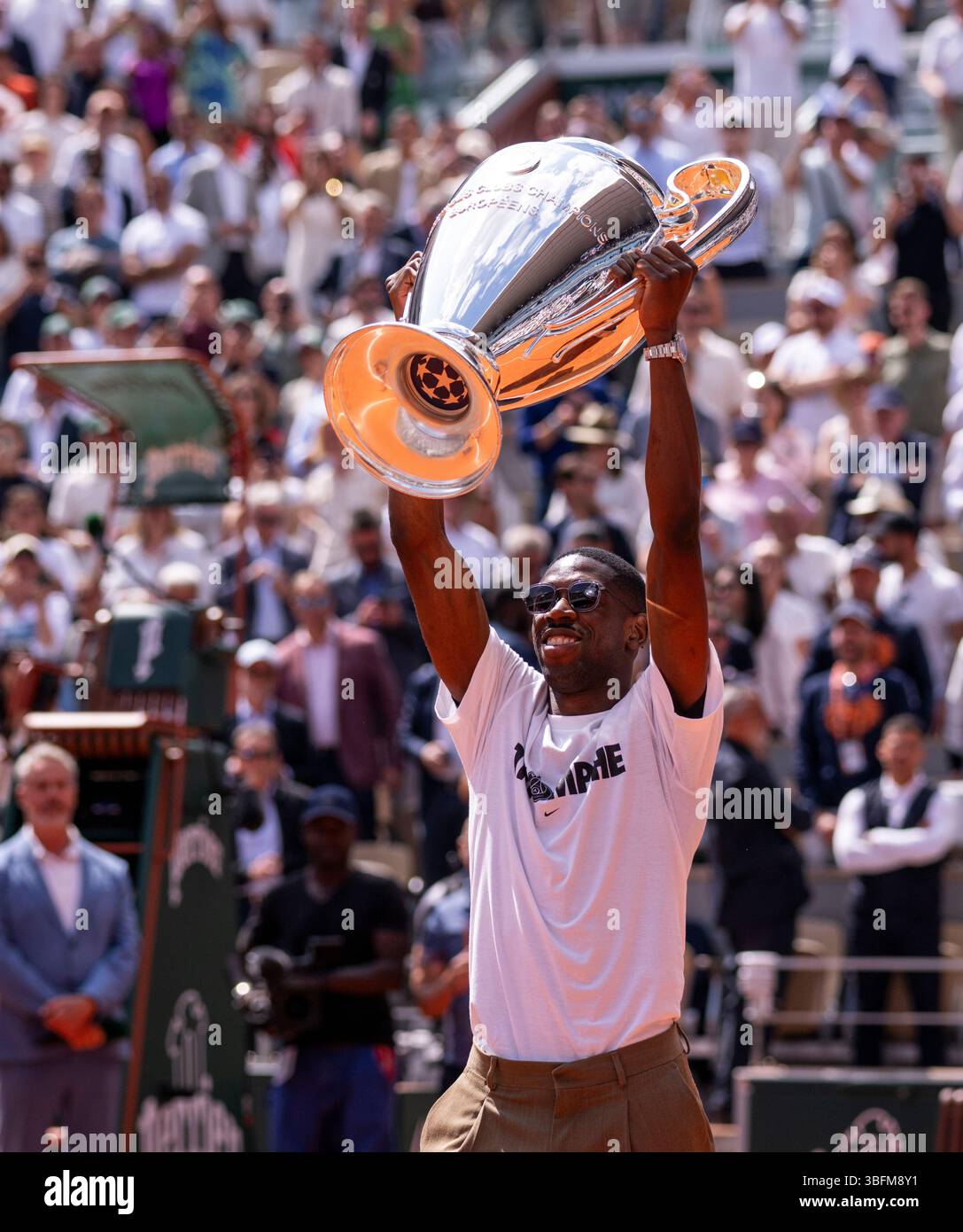 Ousmane Dembele of PSG presents the Champions League Trophy to the ...