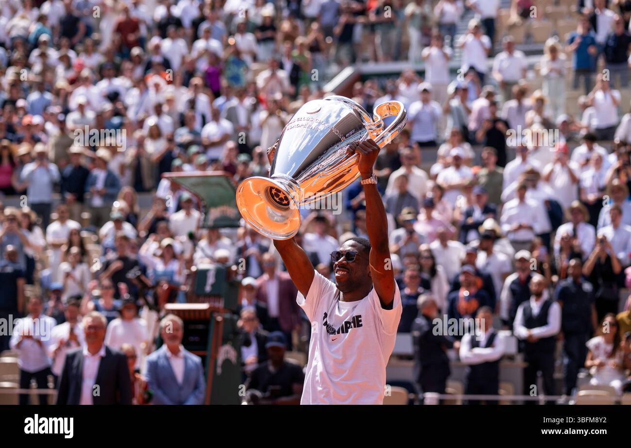 Ousmane Dembele of PSG presents the Champions League Trophy to the ...