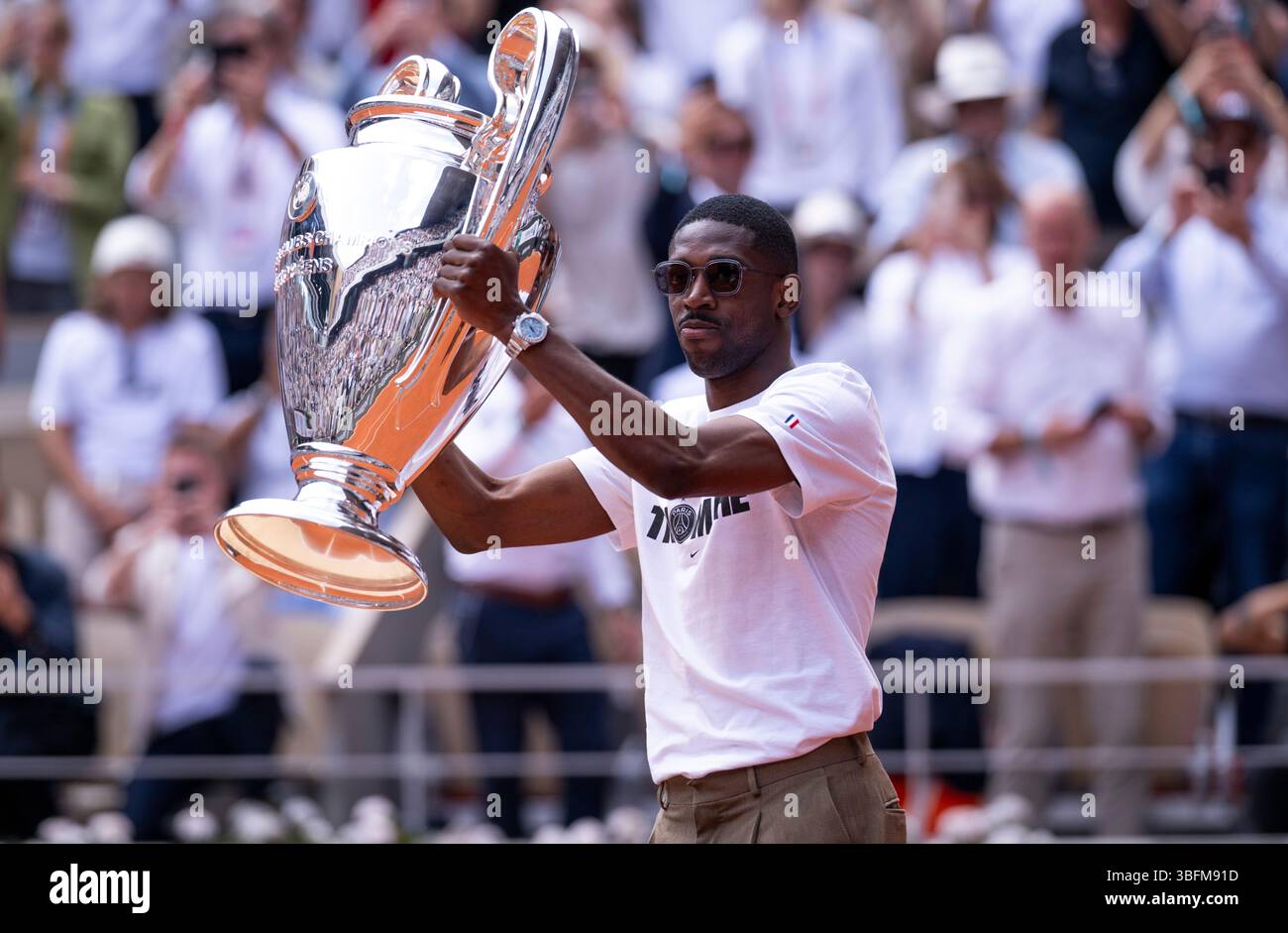 Ousmane Dembele of PSG presents the Champions League Trophy to the ...