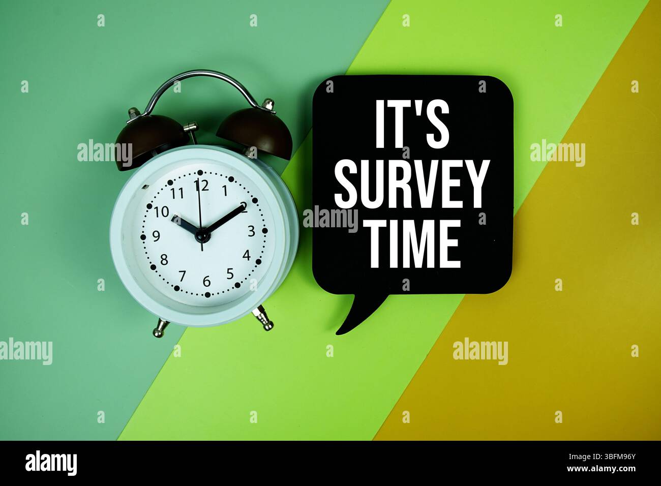 It's Survey Time text on speech bubble with alarm clock top view on ...