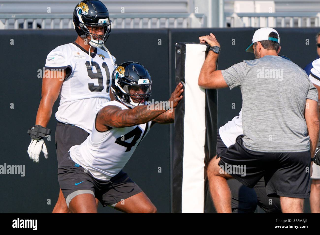 Jacksonville Jaguars defensive end Josh Hines-Allen, center, performs a ...