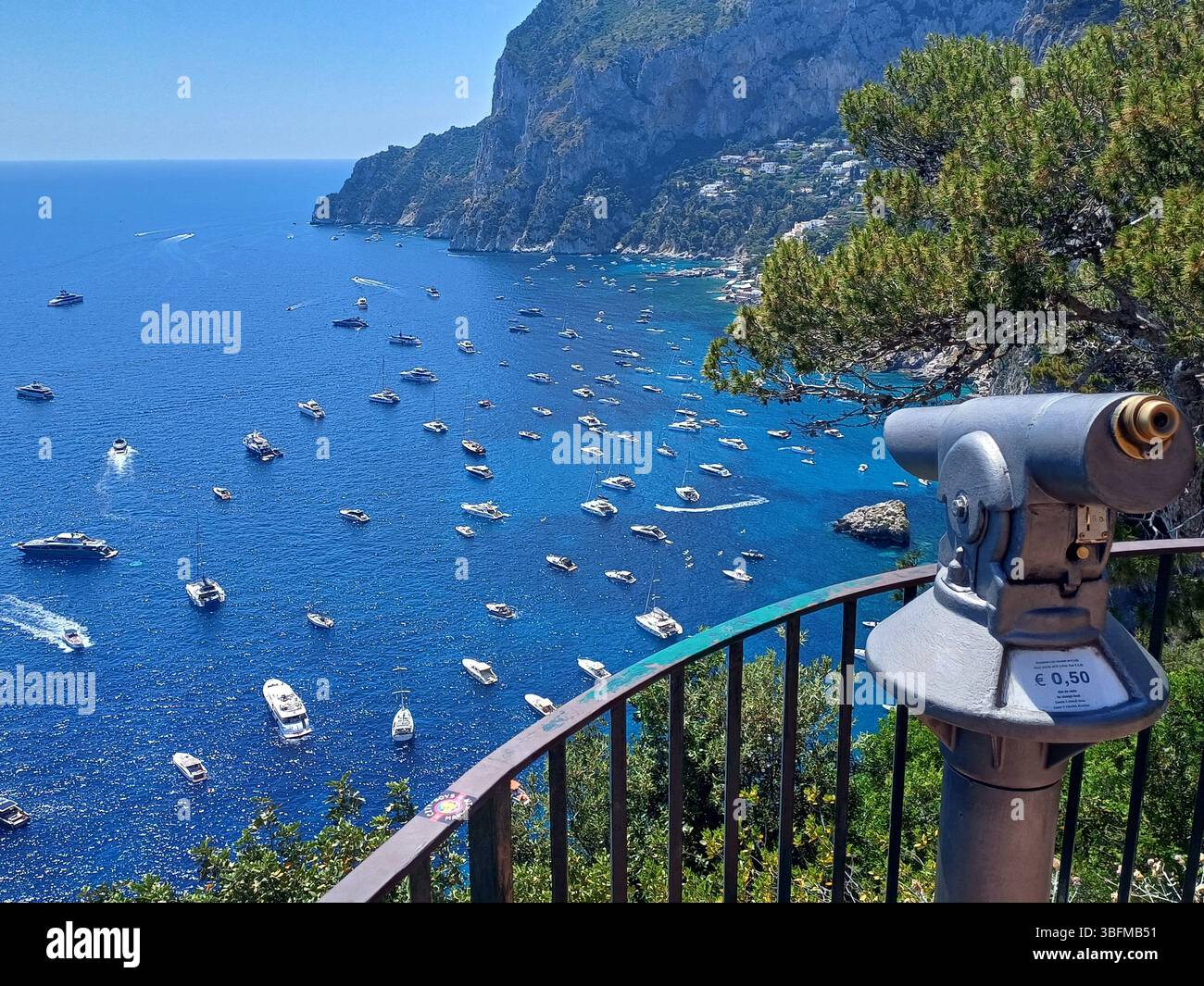 Summer: many tourists and many boats in the sea of Capri island, Italy ...