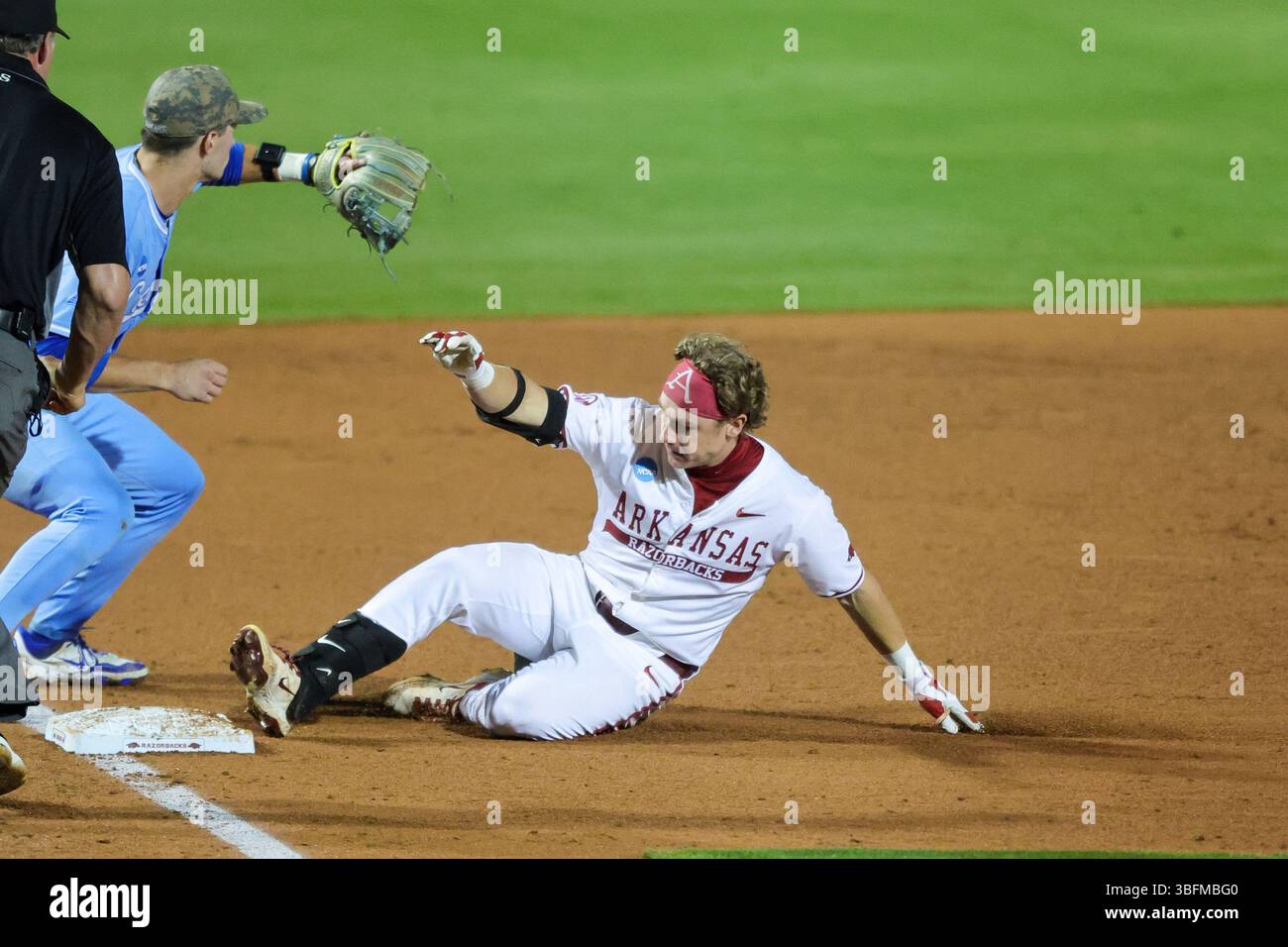 June 1, 2025: Arkansas outfielder Charles Davalan (24) slides safely ...
