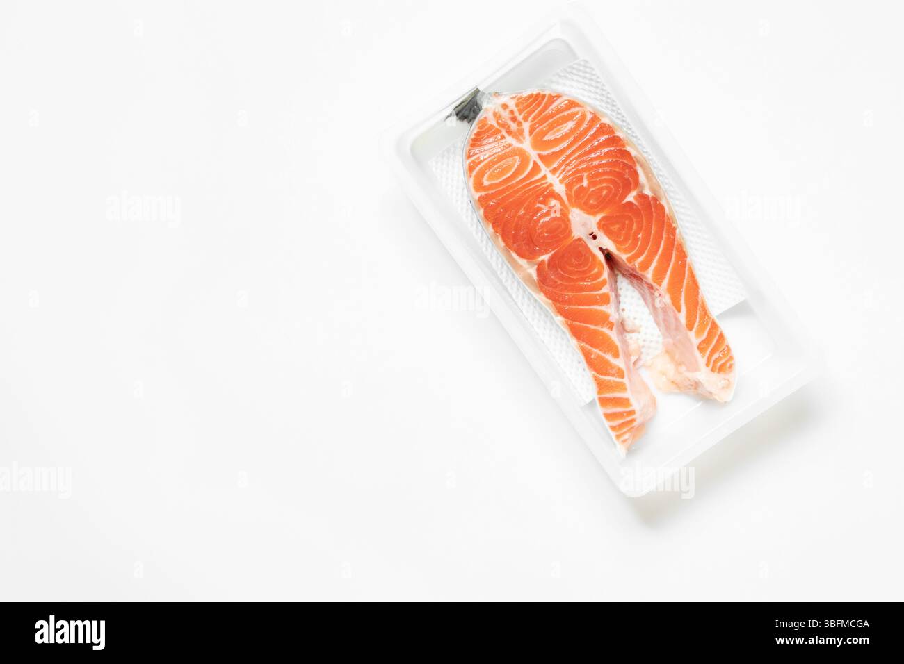 Salmon in plastic packaging on white background, chilled fish Stock ...