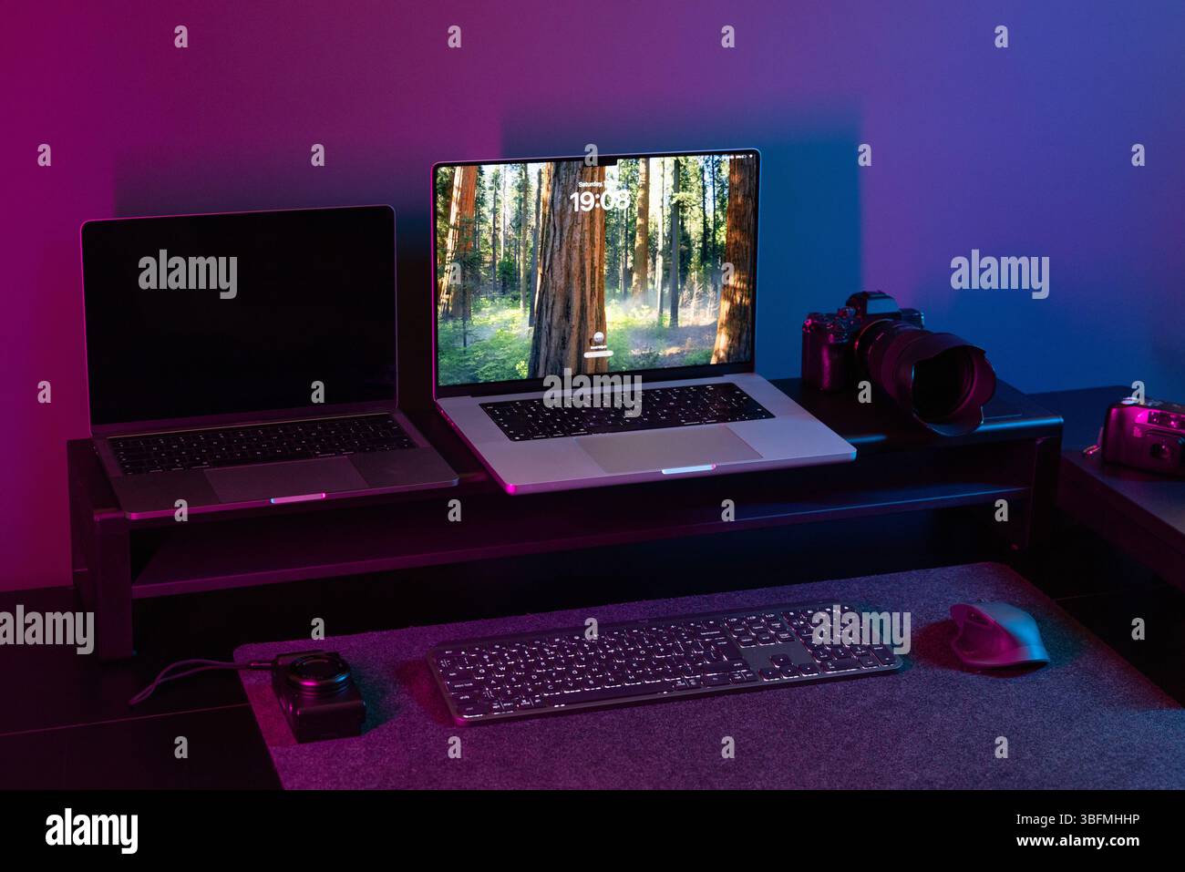 Expansive desk setup for a creative professional featuring two laptops ...