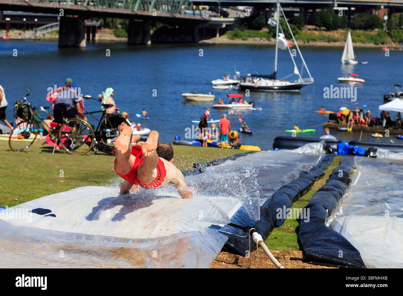 The Big Float, Portland, Oregon - July 15th 2017: A man slides down a ...