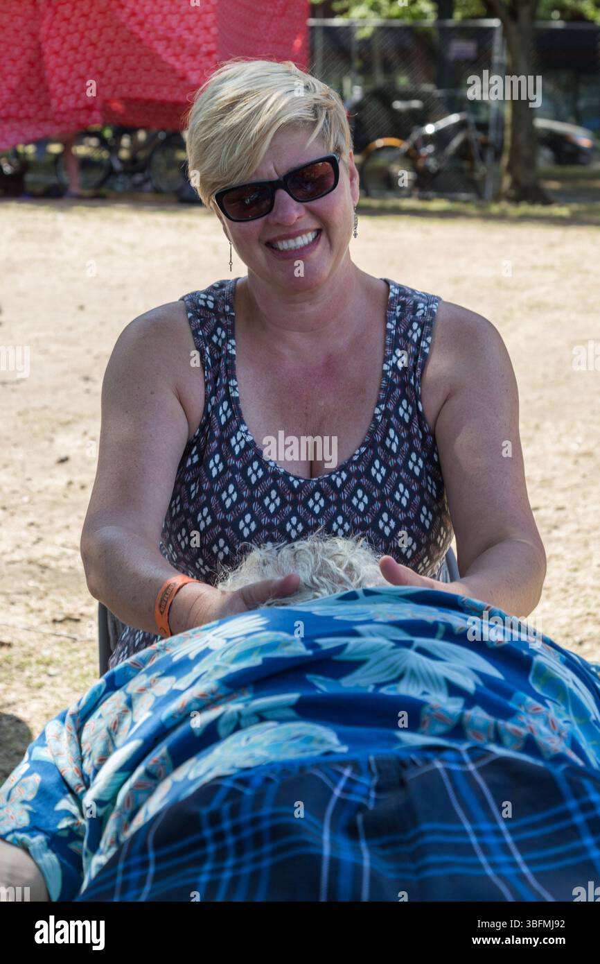 The Big Float, Portland, Oregon - July 15th 2017: A smiling woman gives ...