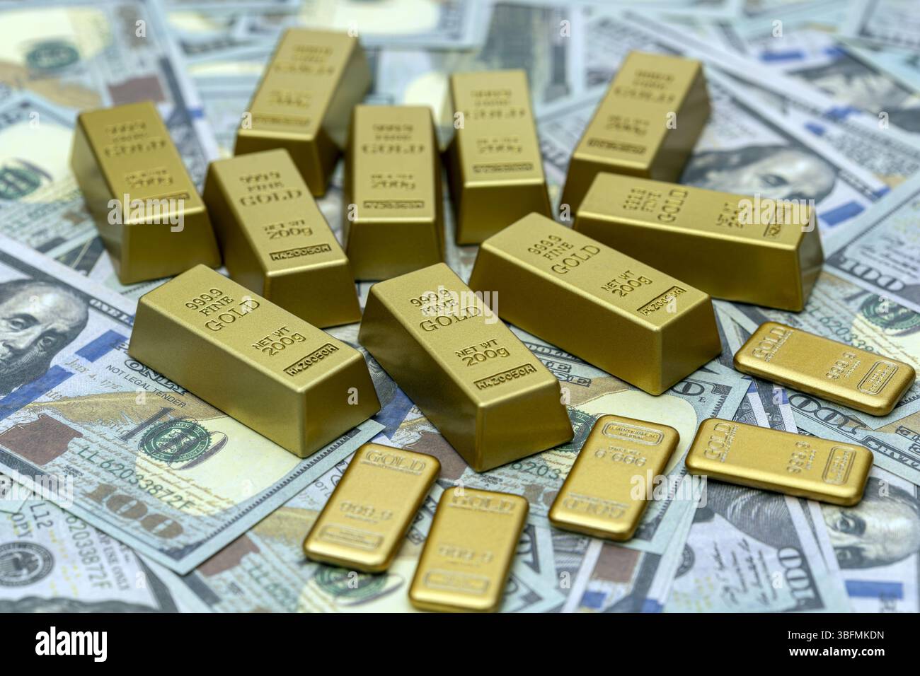 A gold bars are neatly arranged on background of dollar bills ...