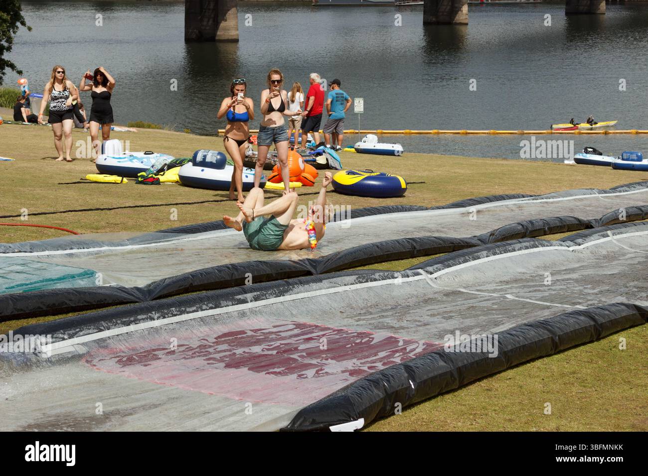 The Big Float, Portland, Oregon - July 10th 2016: A man slides down a ...