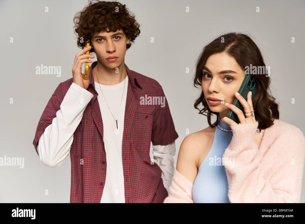 Stylish young couple engaged in a playful conversation, expressing ...