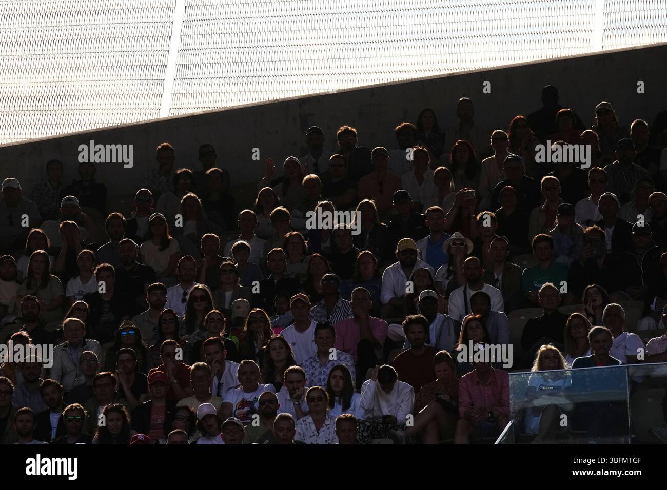 Spectators watch the fourth round match of the French Tennis Open ...