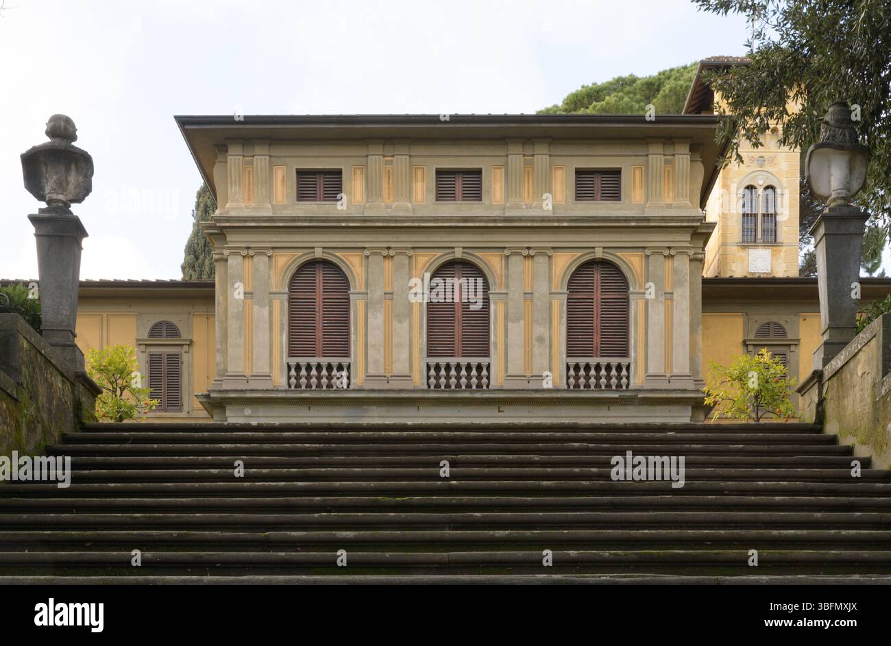 Neoclassical architectural facade with arched windows and columns, part ...