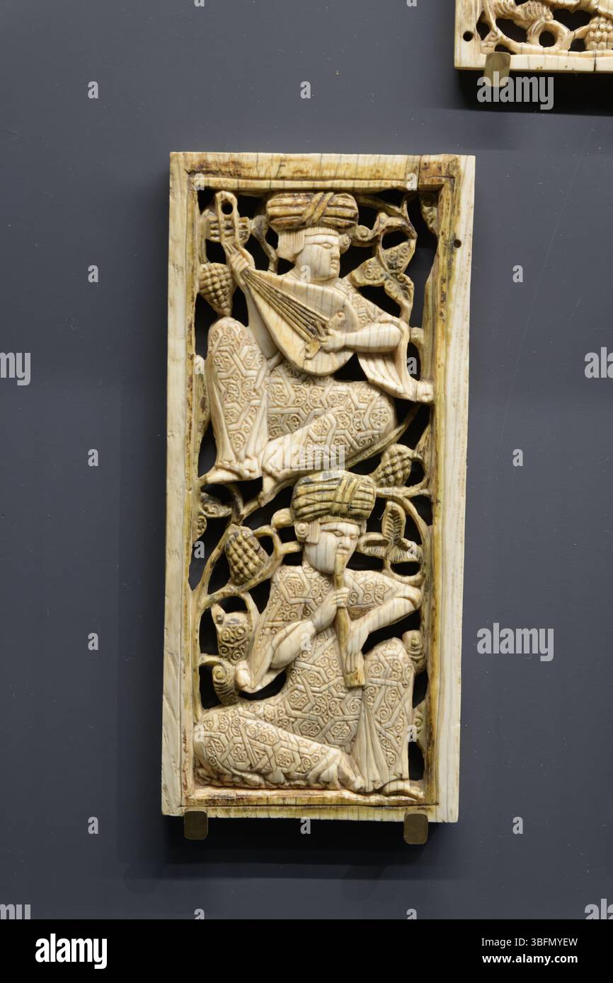 Carved ivory plaque with two musicians in turbans playing lute and ...