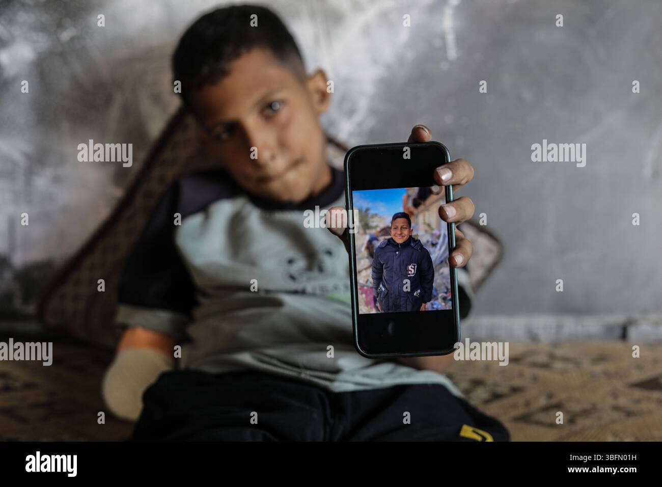 Ahmad Agha, a 14-year-old boy living in a shelter in Gaza City, who was ...