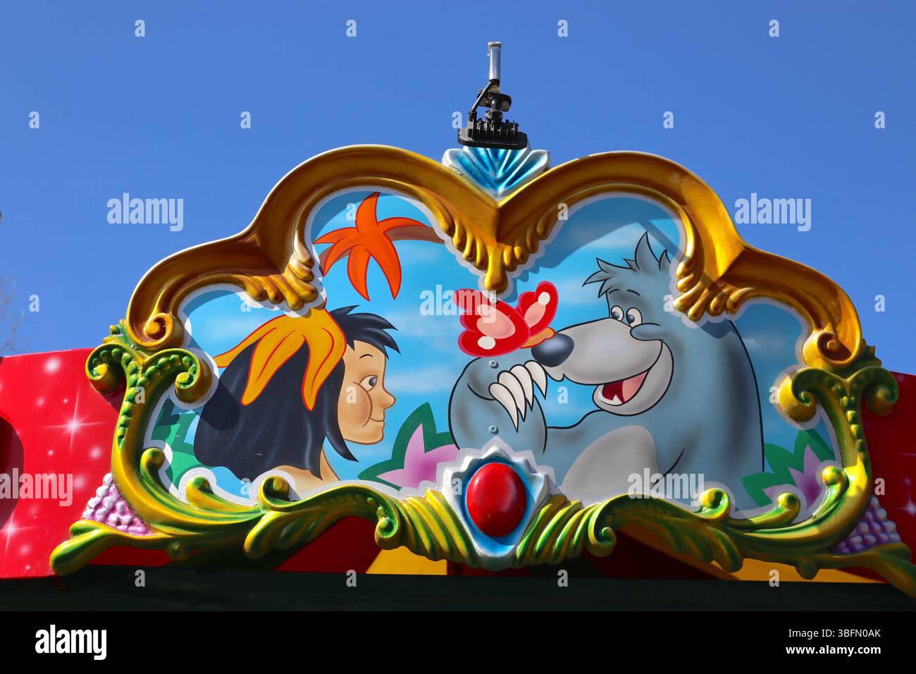 A colourful fairground ride header panel with decorative graphics and ...