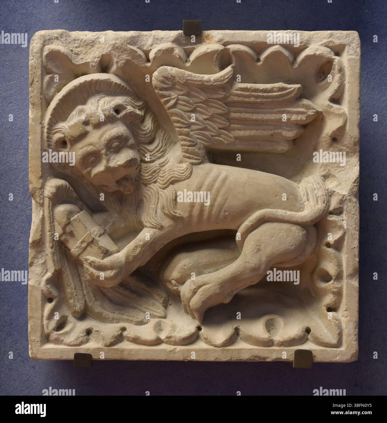 Stone relief depicting the winged Lion of Saint Mark holding a closed ...