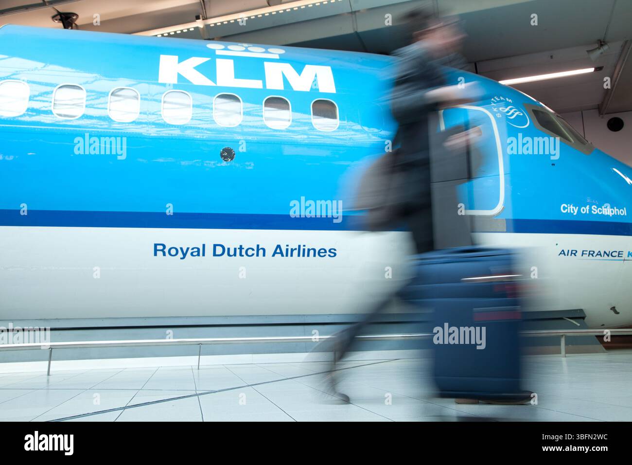 people passing by a KLM plane in Schipol Airport in Amsterdam 2014 ...