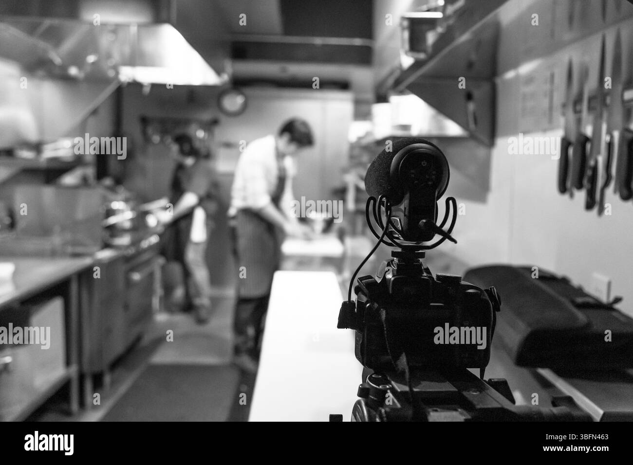 A camera films chefs in a restaurant kitchen, capturing their culinary ...