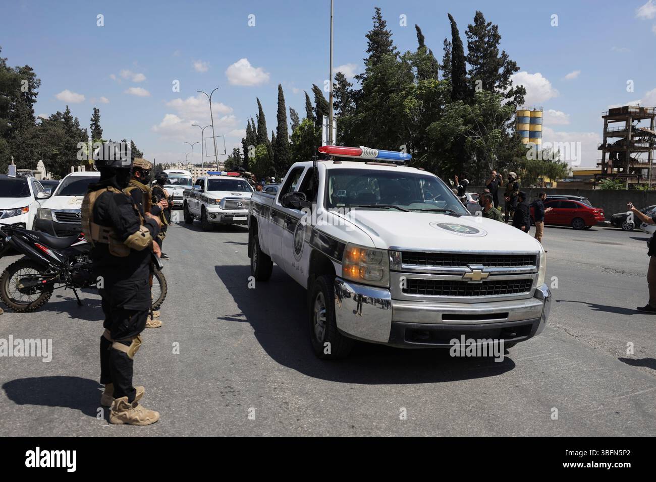 Government security forces escort a convoy of vehicles during a ...