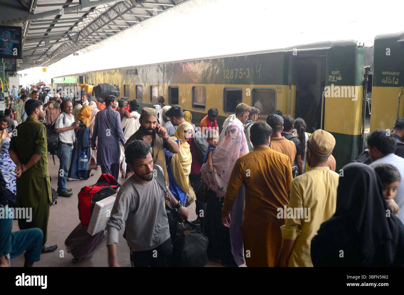 A large number of people gather for boarding on special Eid train as they are going to their ...