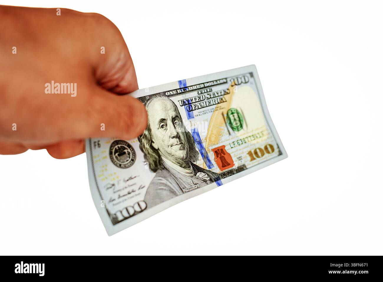 A close-up image of a hand holding a crisp 100 dollar bill ...