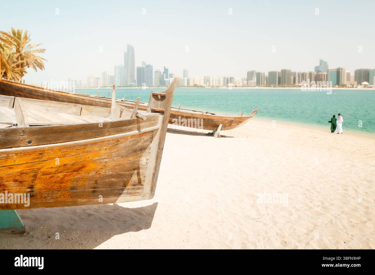 Abu Dhabi skyline and old traditional fishing boats in Heritage Village ...