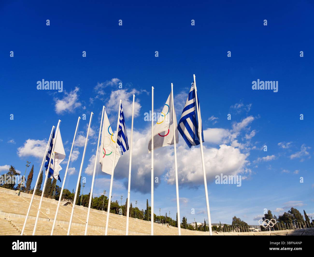 Multiple Greek and Olympic flags in Panathenaic stadium waving on tall ...