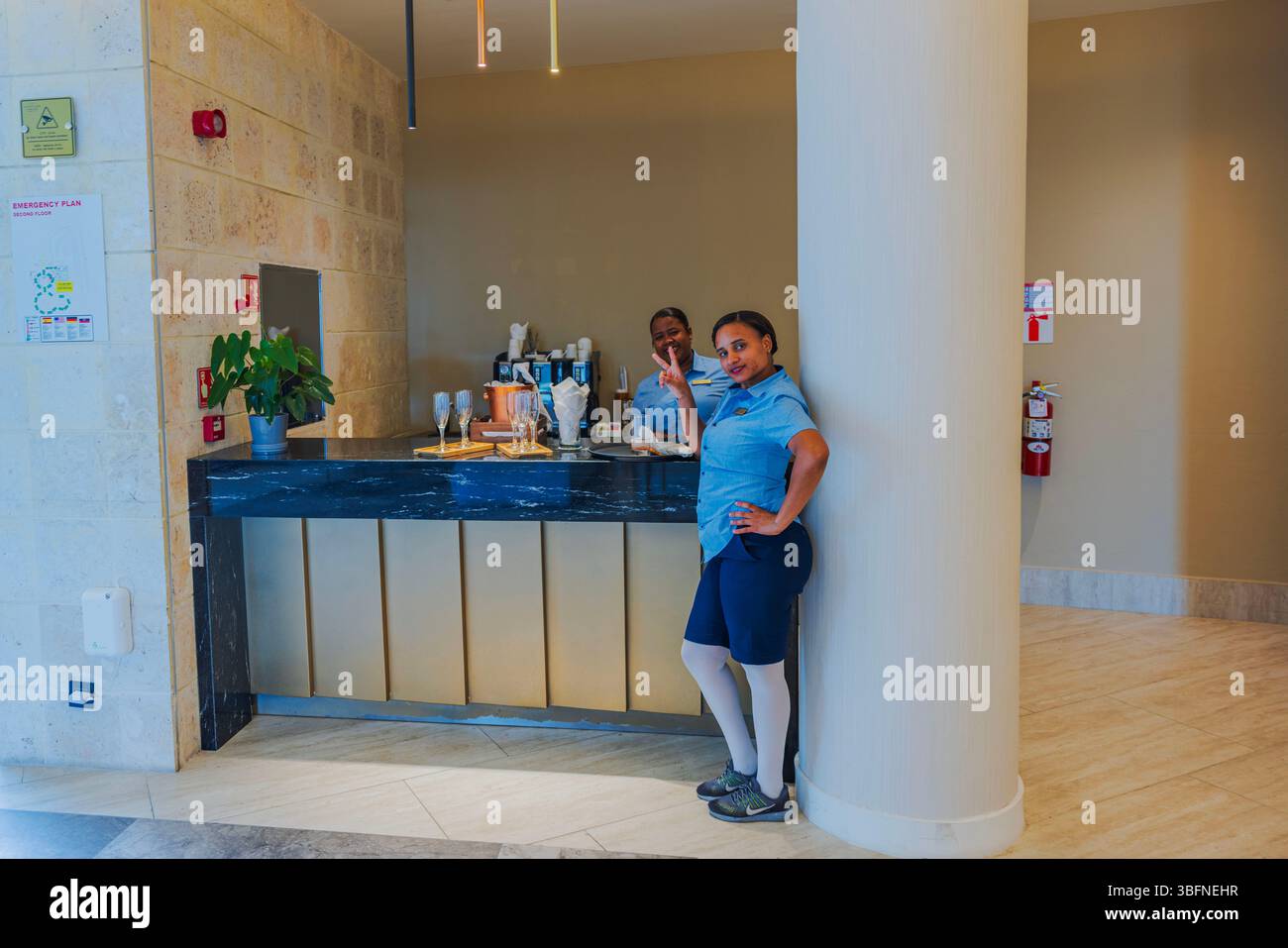 Friendly hotel staff posing at drink counter inside Breathless Punta ...