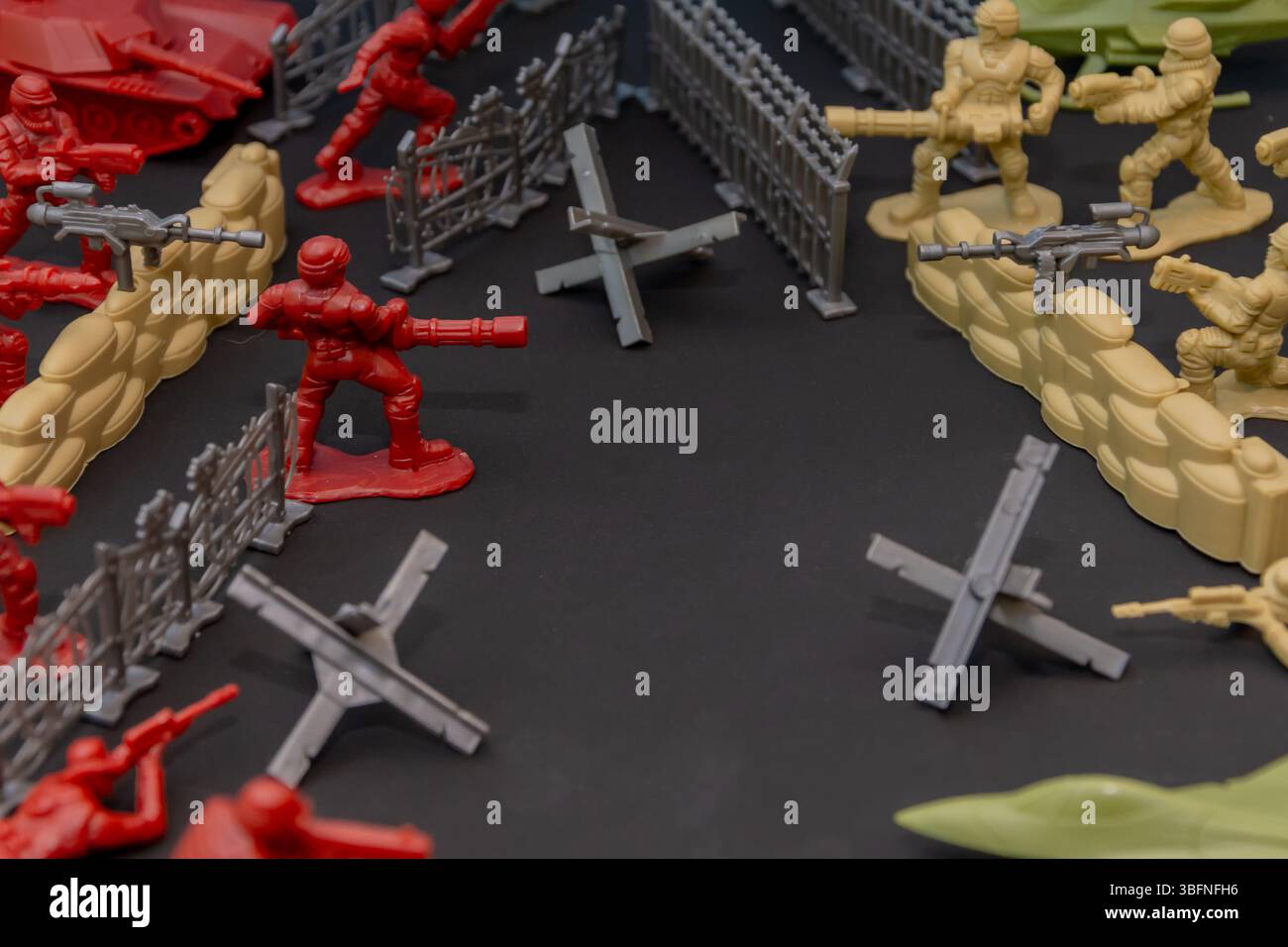 A battle scene with toy soldiers. Plastic soldiers, fortifications ...