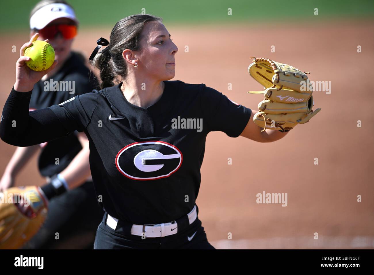 Georgia pitcher Rachel Gibson throws after fielding a bunt during an ...