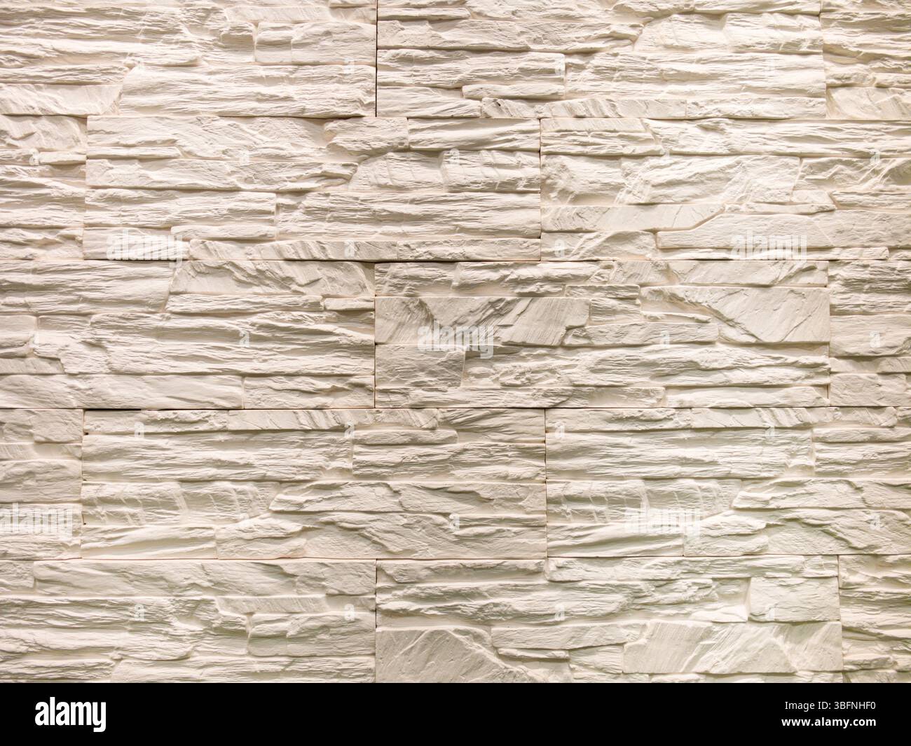 Textured decorative tiles adorn a modern interior wall, providing a ...