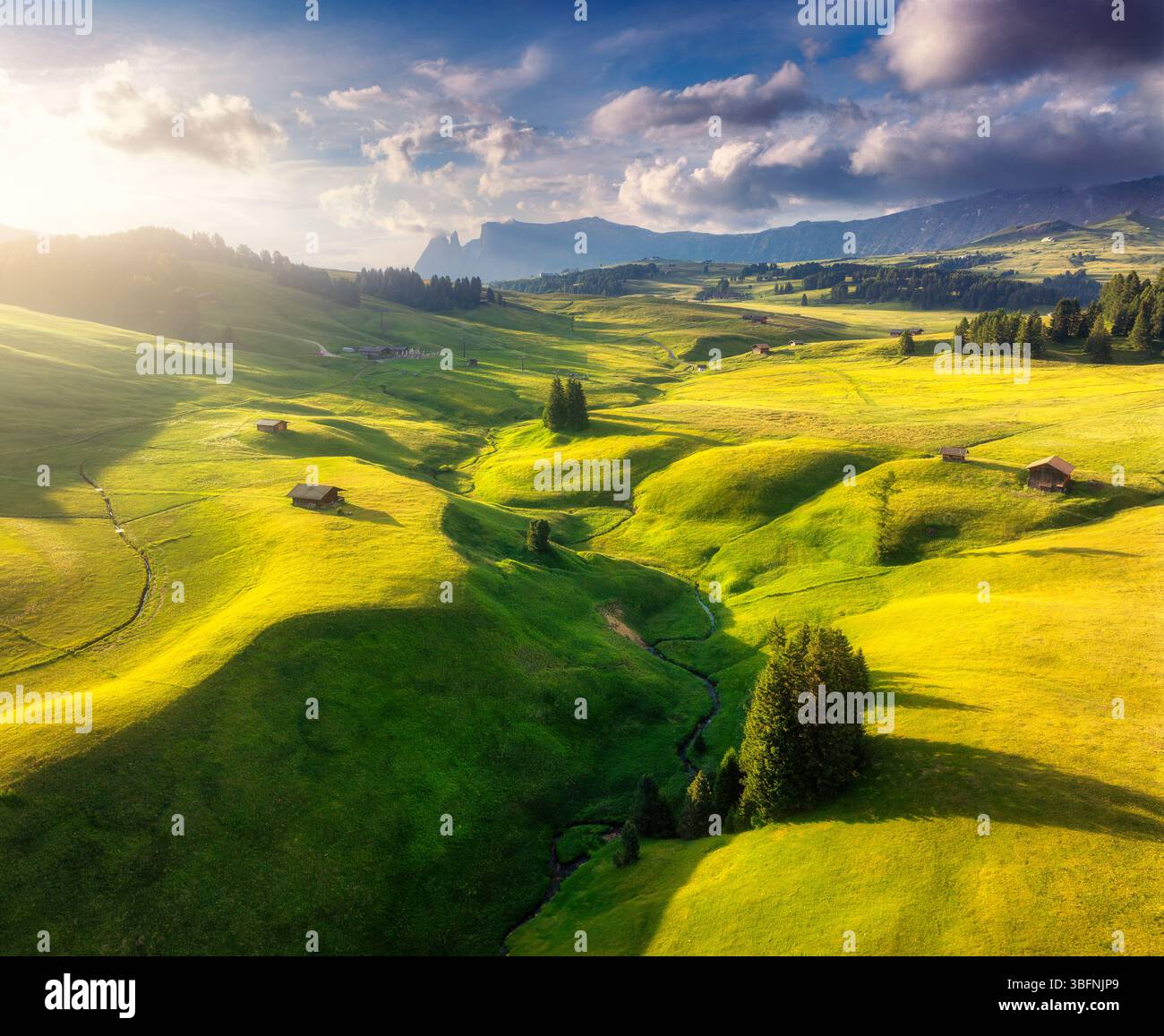 Aerial view of green alpine meadows with houses on the hills Stock ...