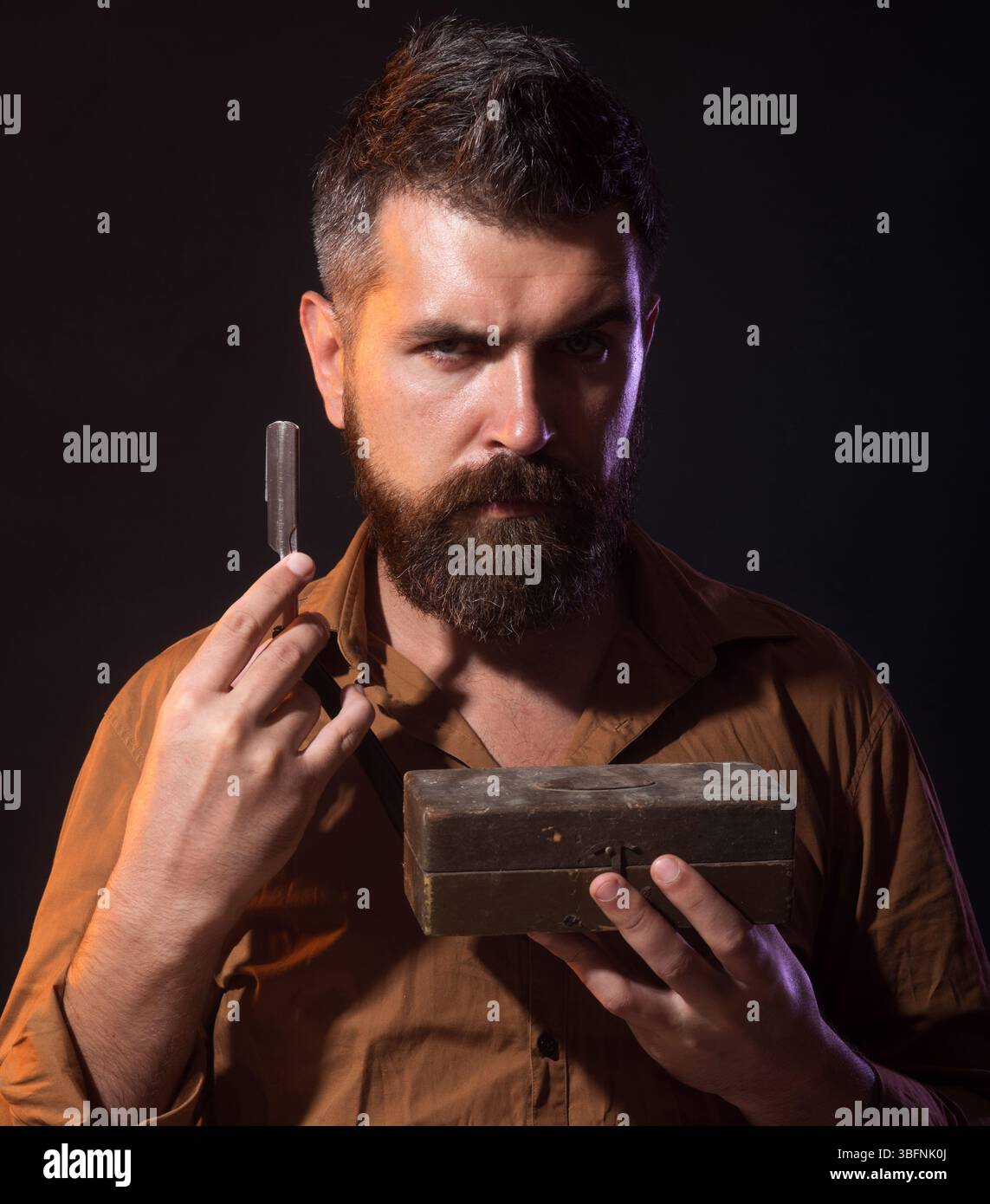 Barbershop. Barber with dangerous straight razor for shaving and wooden ...