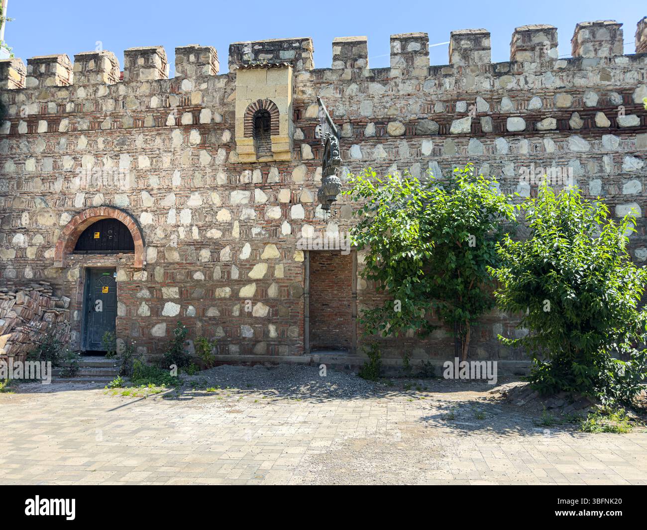 Medieval fortress wall with stone texture, battlements, doors and ...