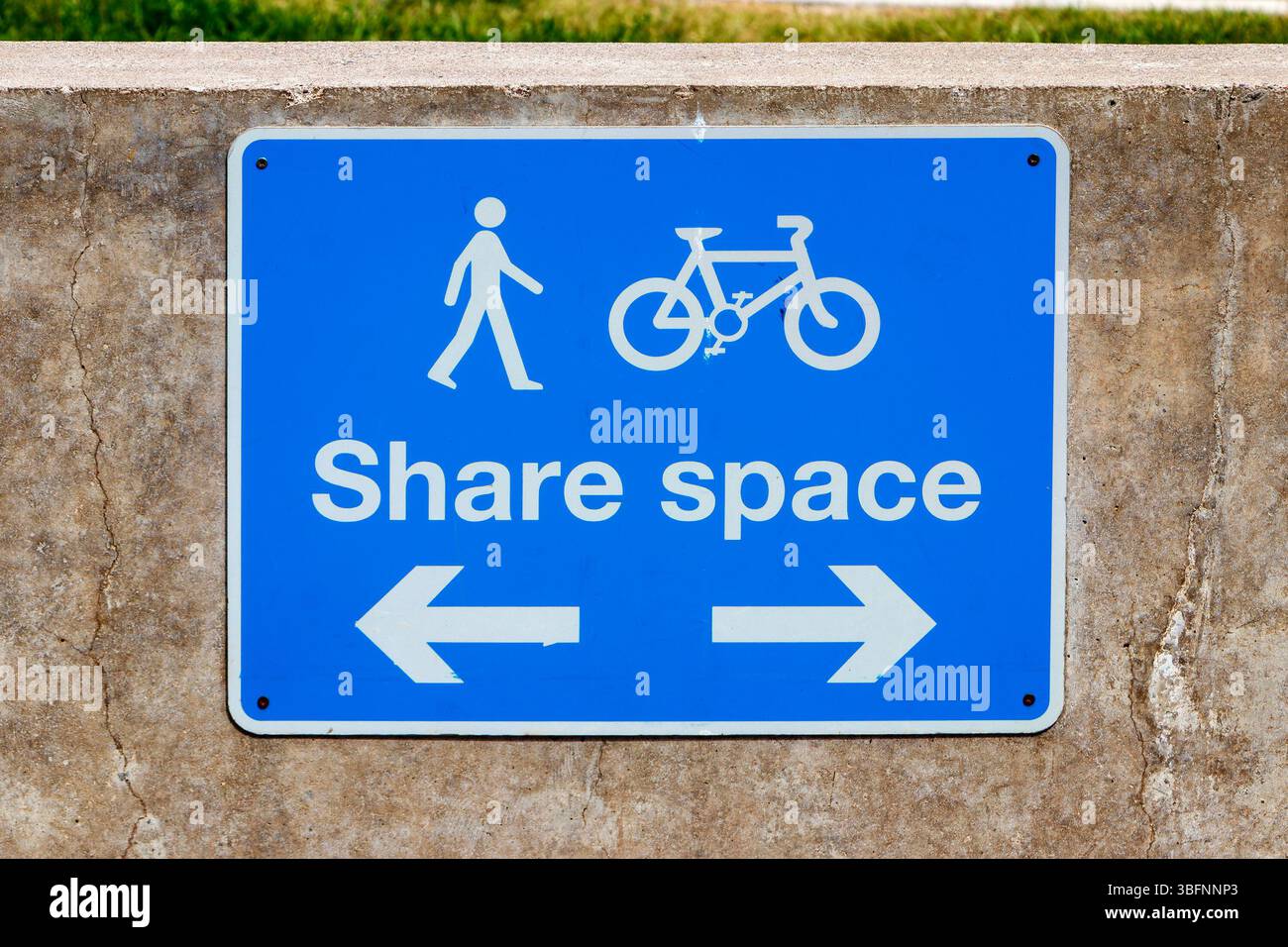Blue sign indicating a shared space for pedestrians and cyclists on a ...