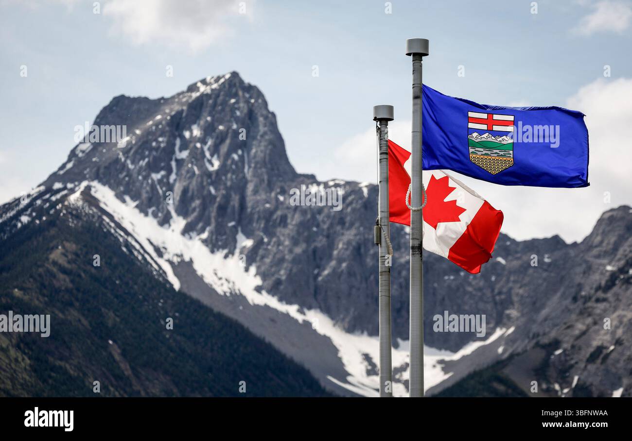 A Canada flag, left, and an Alberta flag flap in the breeze with Wedge ...