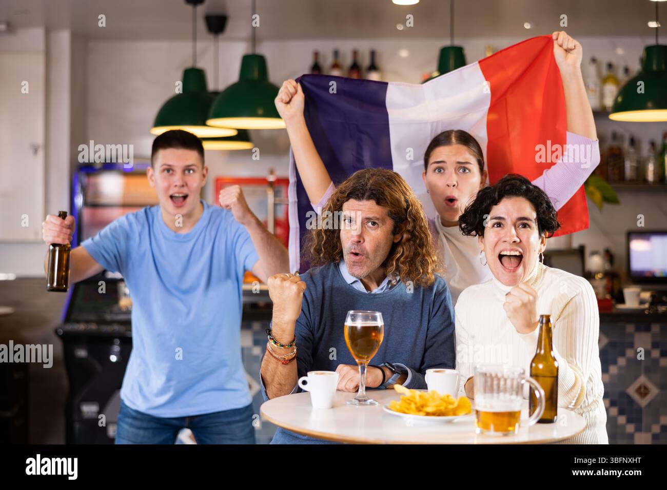 Group of emotive friends, supporters cheering for favorite team with ...