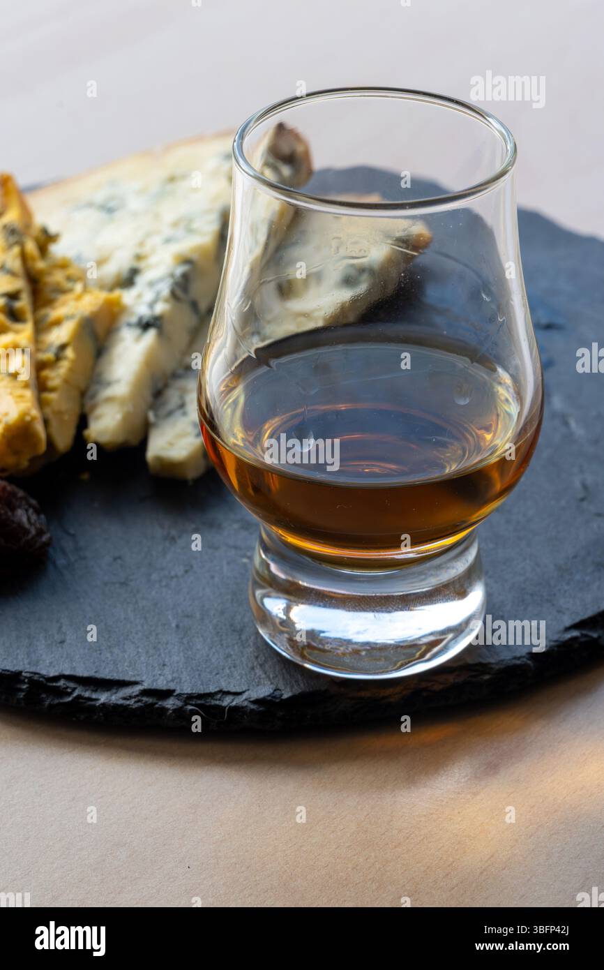 Whiskey and cheese pairing, tasting scotch whisky glass and plate with ...